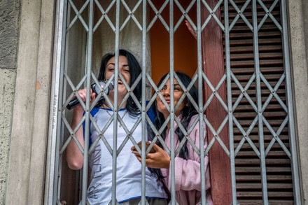 Quarantined girls at home for the emergency COVID19 Coronaviru sing ...