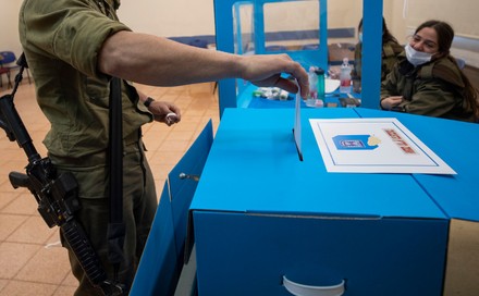 Israeli soldiers cast their votes in early elections at their base in ...
