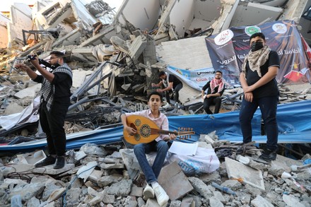Palestinian artists perform during an event on the rubble of Hanadi ...