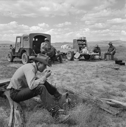 Cowboys Seated Around Camp Eating On Editorial Stock Photo - Stock ...
