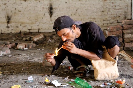 Pakistani Drug Addict Smokes Heroine On Editorial Stock Photo - Stock ...