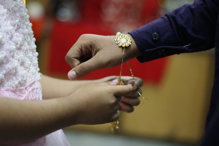Hindu performs religious rituals after tying Rakhi (sacred thread) on ...
