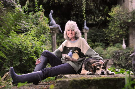 Jilly Cooper in her garden at home in the village of Bisley near Stroud ...