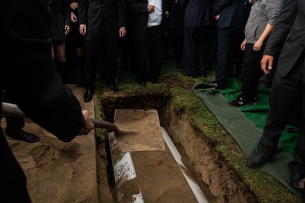 Mourners Shovel Dirt Over Coffin During Editorial Stock Photo - Stock ...