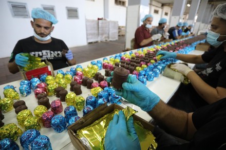Palestinian workers prepare the vanilla candy known as "Ras El-abed or ...