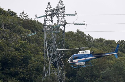 A helicopter from the RTE company that monitors high-voltage power ...