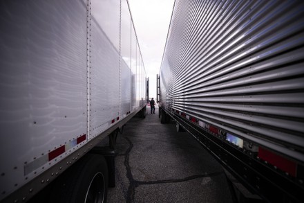 Trucker Walks Between Two Trucks During Editorial Stock Photo - Stock ...