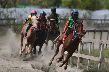 Young Jockeys Race Their Horses During Editorial Stock Photo - Stock ...