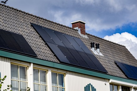 Solar panels on roofs in a residential area in Poeldijk, Netherlands ...