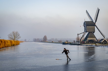 People Skating Between Windmills Kinderdijk On Editorial Stock Photo ...