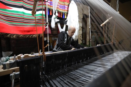 __COUNT__ Palestinian man Akram al-Yaziji, 65, weaves on wooden loom ...