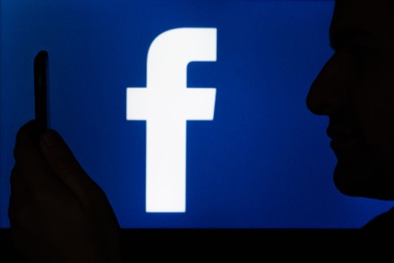 Facebook Logo Background Behind Man Using Editorial Stock Photo - Stock ...