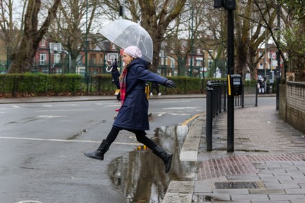 Woman Umbrella Jumps Over Puddle Rainwater Editorial Stock Photo ...