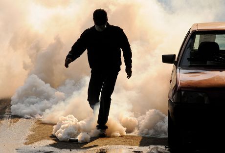 Man Kicks Away Tear Gas Canister Editorial Stock Photo - Stock Image ...