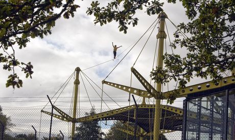 __COUNT__ High-wire acrobat crosses wire strung between pillars of ...