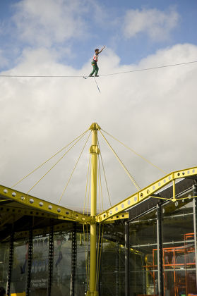 __COUNT__ High-wire acrobat crosses wire strung between pillars of ...