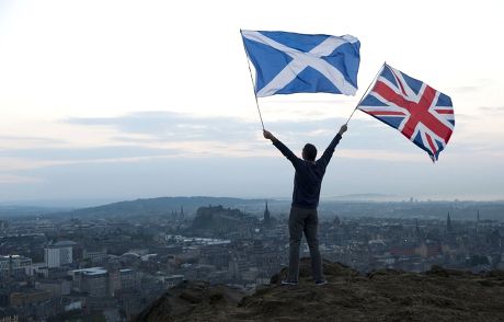 Scottish Saltire and British Union flags being held aloft on Arthur's ...