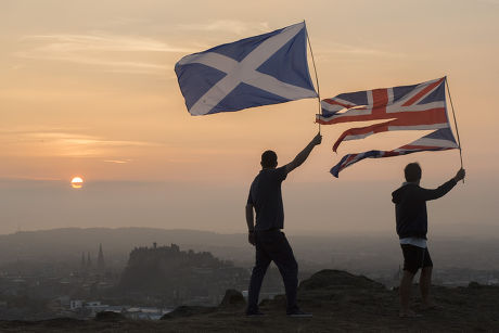 Scottish Saltire and British Union flags being held aloft on Arthur's ...