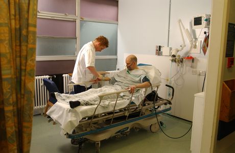 Male Nurse Inserts Intravenous Drip Into Editorial Stock Photo - Stock ...