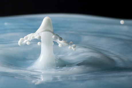 Milk Dropping Into Blue Water Editorial Stock Photo - Stock Image ...