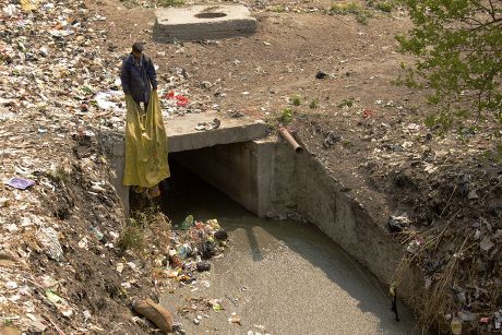 Man Disposing His Waste Into Canal Editorial Stock Photo - Stock Image ...
