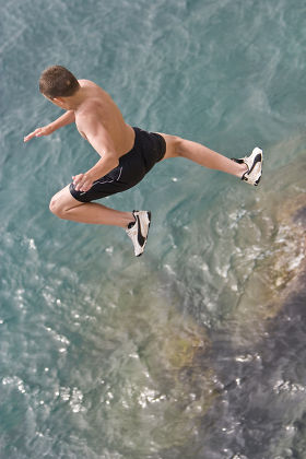 Young Cliff Jumper On Beach On Editorial Stock Photo - Stock Image ...