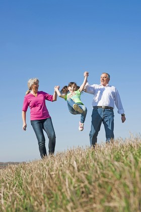 Model Released Grandparents Swinging Their Granddaughter Editorial ...