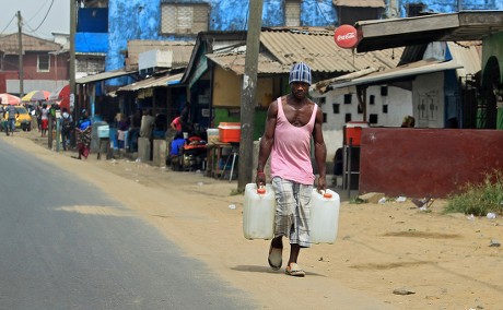 Liberian Man Carrying Water Gallons On Editorial Stock Photo - Stock ...