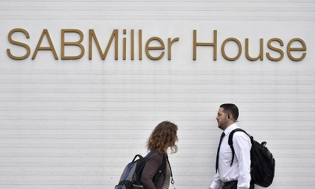 People Walk Past Sabmiller Logo Outside Editorial Stock Photo - Stock ...