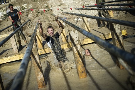 Competitor Falls On Obstacle During First Editorial Stock Photo - Stock ...