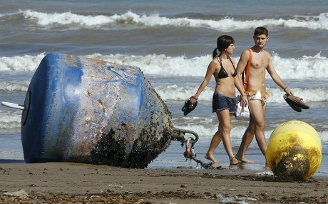 Couple Passes By Two Buoys Stranded Editorial Stock Photo - Stock Image | Shutterstock