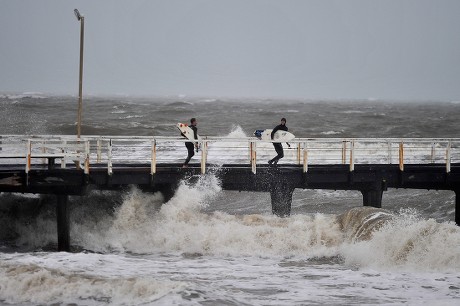 Surfers On Jetty Look Jump Into Editorial Stock Photo - Stock Image ...