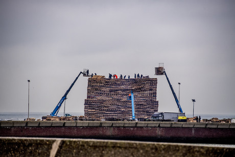 Preparations for the annual new years bonfire at the beach of ...