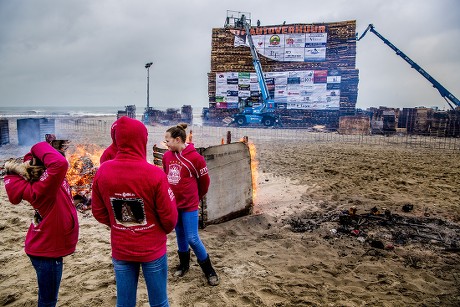 Preparations for the annual new years bonfire at the beach of ...