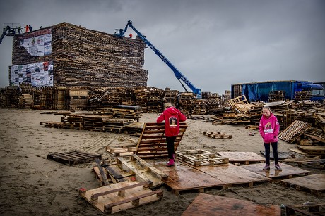 Preparations for the annual new years bonfire at the beach of ...