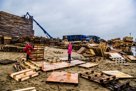 Preparations for the annual new years bonfire at the beach of ...