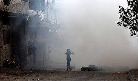 Palestinian Stands Amidst Tear Gas Smoke Editorial Stock Photo - Stock ...