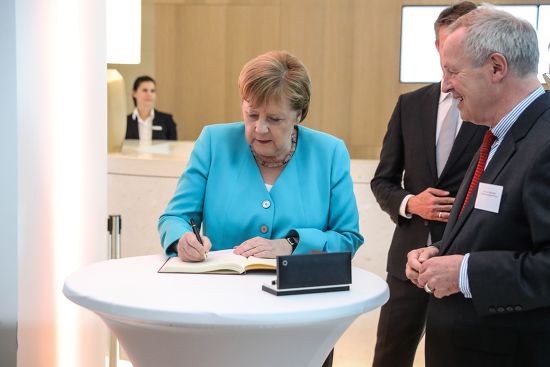 German Chancellor Angela Merkel Signs Guest Editorial Stock Photo ...