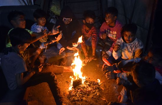 Children Warm Themselves Around Bonfire On Editorial Stock Photo ...
