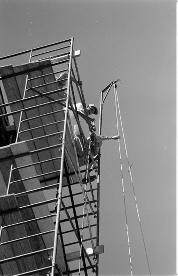 Man On Scaffolding Using Pulley During Editorial Stock Photo - Stock ...