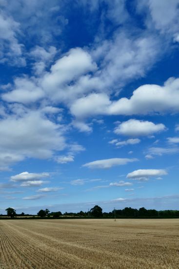 Blue Skies White Floaty Clouds Over Editorial Stock Photo - Stock Image | Shutterstock