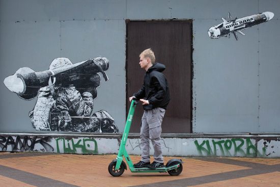 Boy Rides Scooter By Graffiti Depicting Editorial Stock Photo - Stock ...