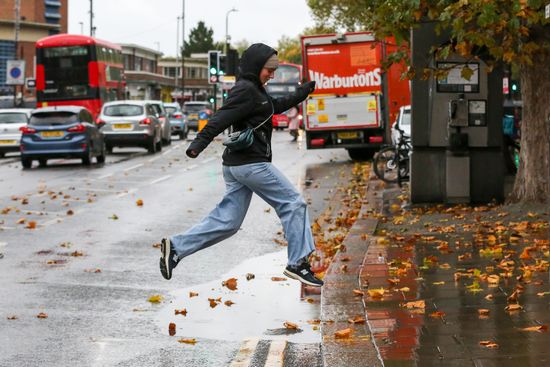 Woman Jumps Over Large Puddle Rainwater Editorial Stock Photo - Stock ...