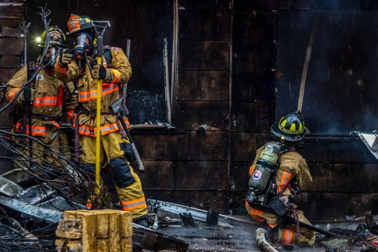 Firefighter Works Hose While Others Communicate Editorial Stock Photo ...