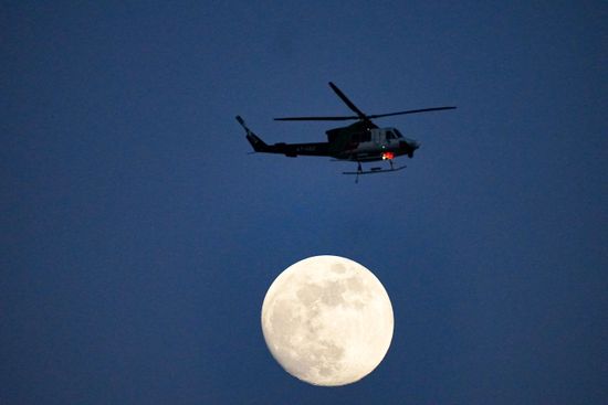 Helicopter Flys Past Rising Moon Editorial Stock Photo - Stock Image ...