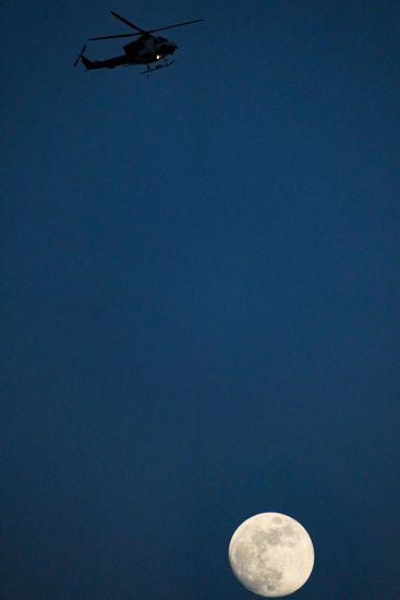 Helicopter Flys Past Rising Moon Editorial Stock Photo - Stock Image ...