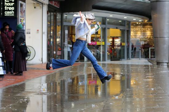 Woman Jumps Over Large Puddle Rainwater Editorial Stock Photo - Stock ...