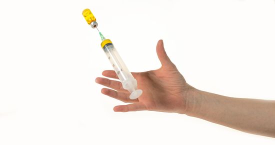 Syringe Falling Into Hand Against White Editorial Stock Photo - Stock ...