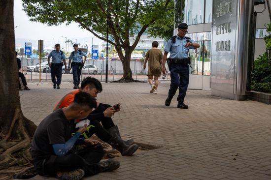 Police Officers Walks Pass Workers Siting Editorial Stock Photo - Stock ...