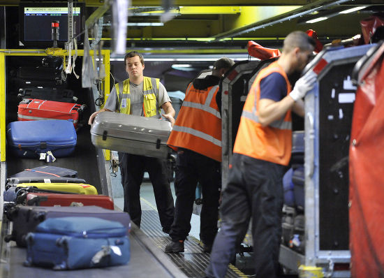 Baggage Handlers Put Baggage Onto Conveyor Editorial Stock Photo ...
